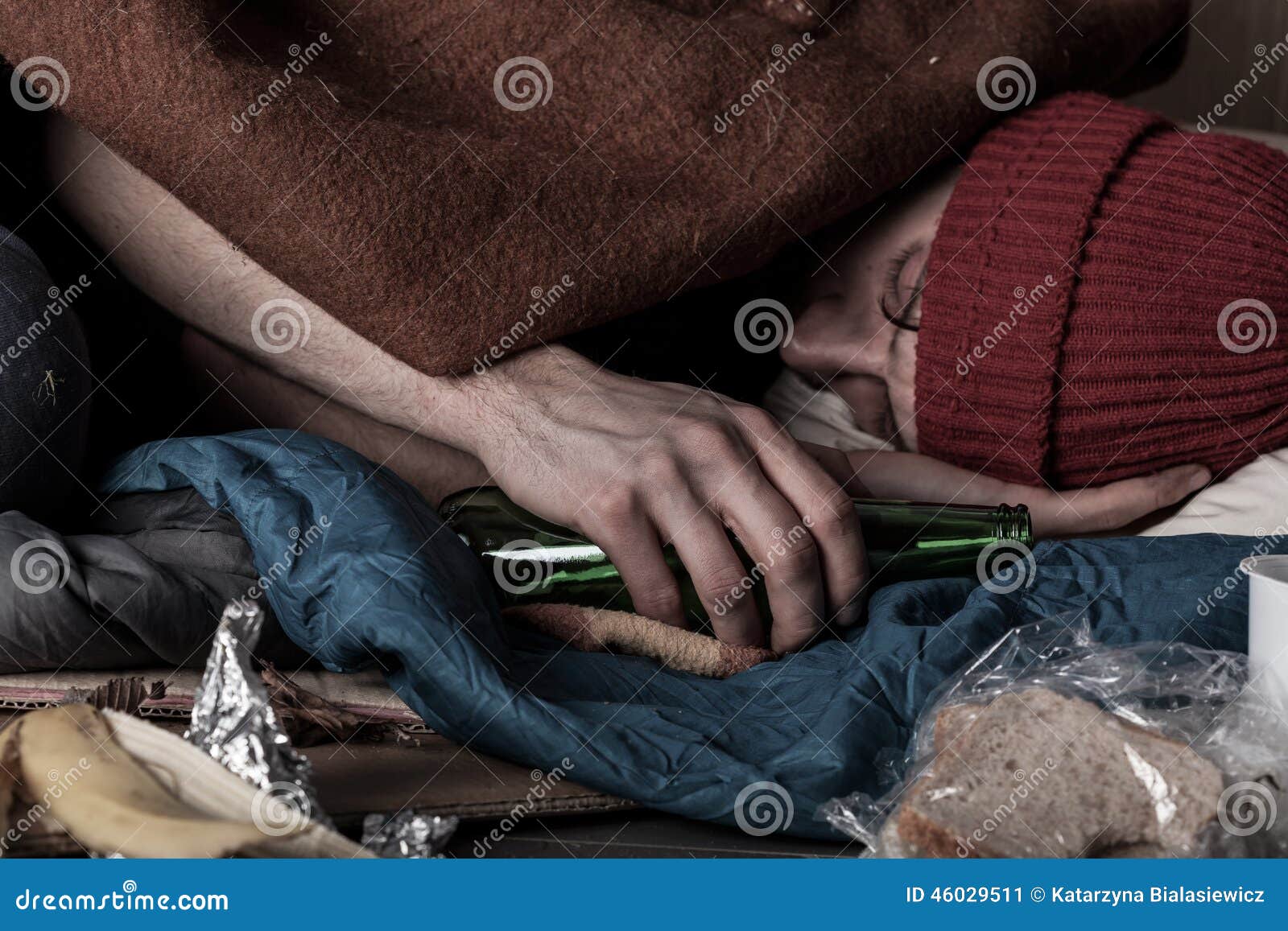 Drunk Homeless Man Sleeping With A Bottle Of Alcohol In His Hands On A ...