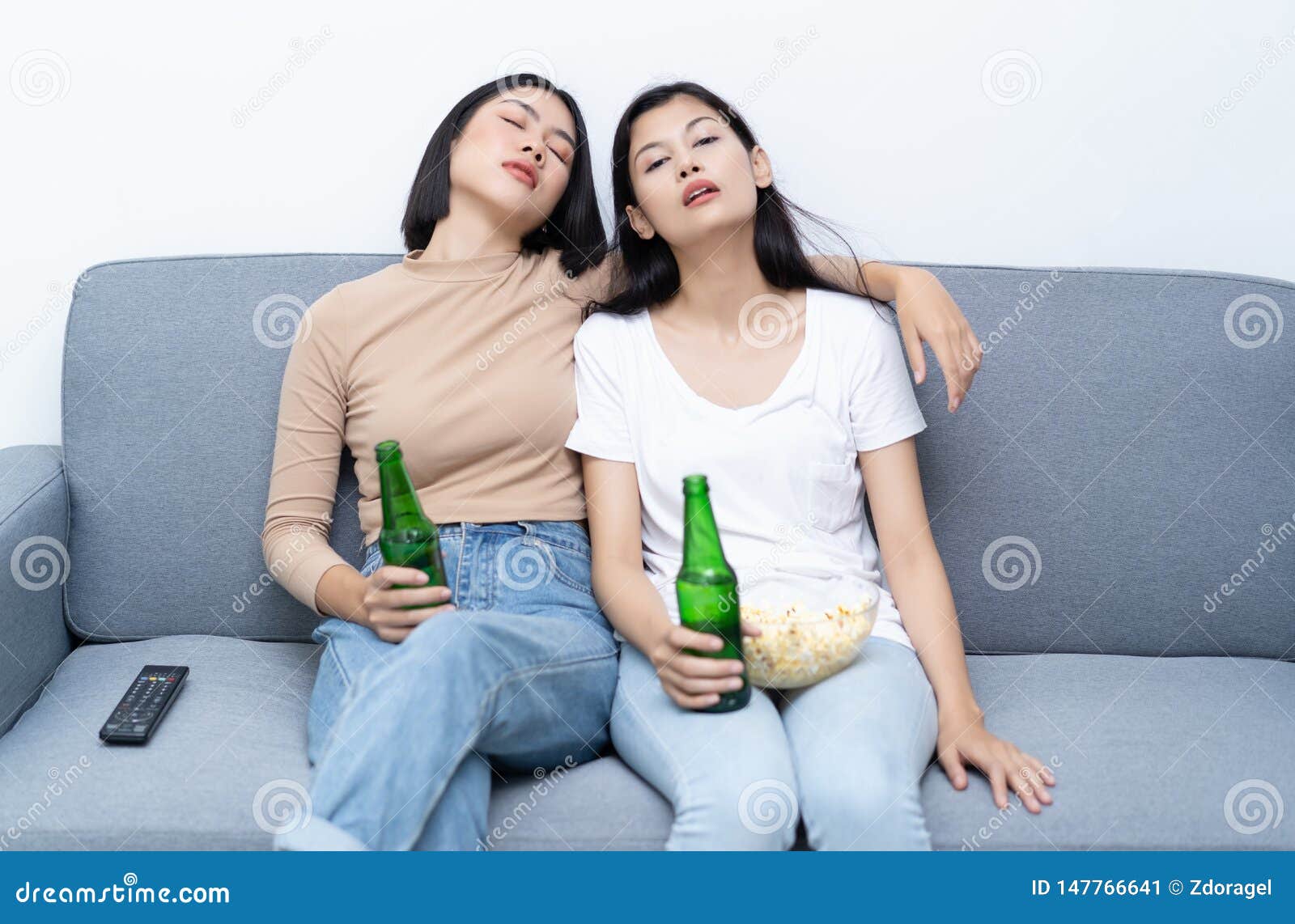 Drunk Lesbian Couple Young Asian Woman Sitting On The Sofa In Livingroom Emotions Concept Stock