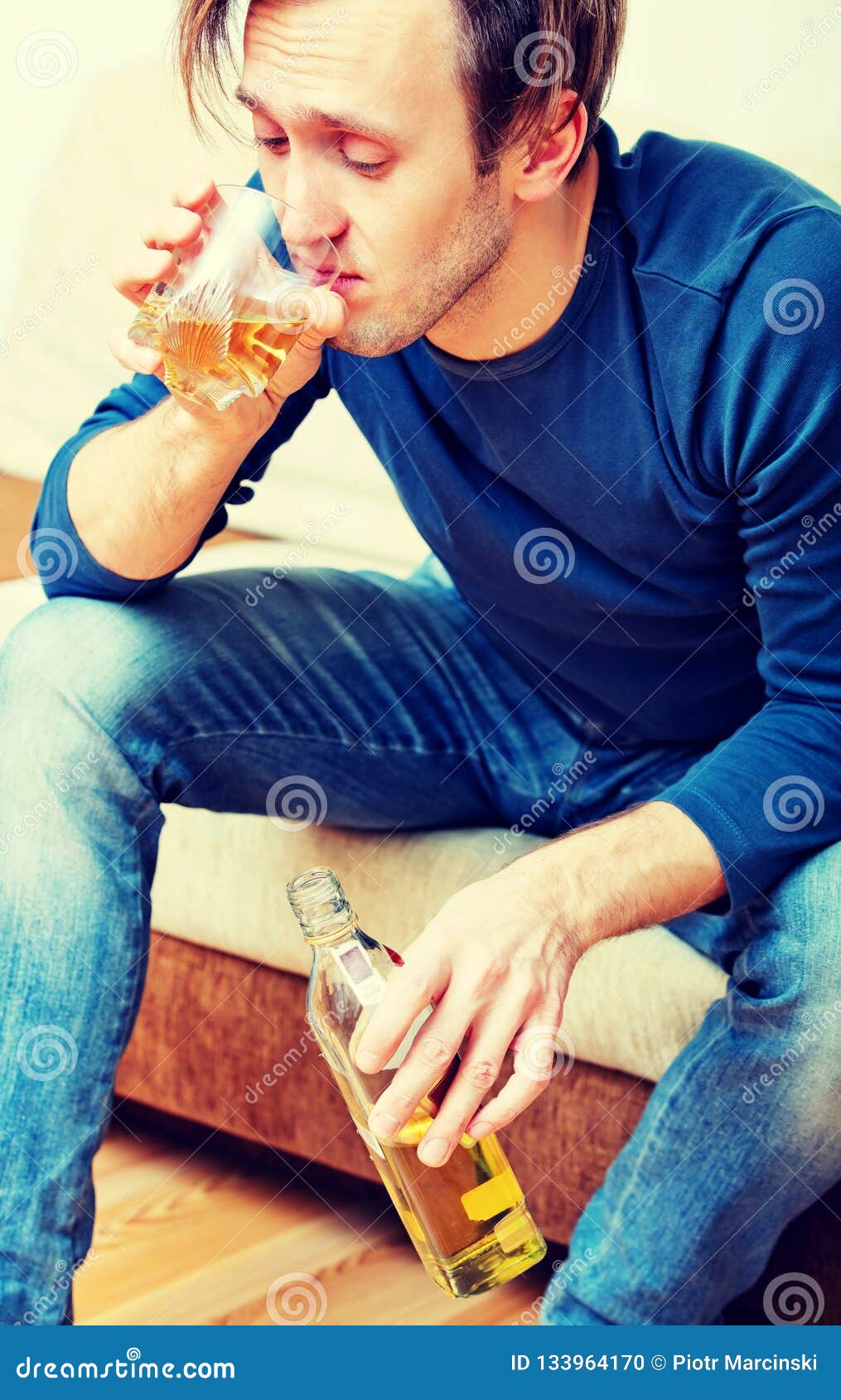 Drunk Man Sitting on Couch and Drinking Whiskey Stock Photo - Image of ...