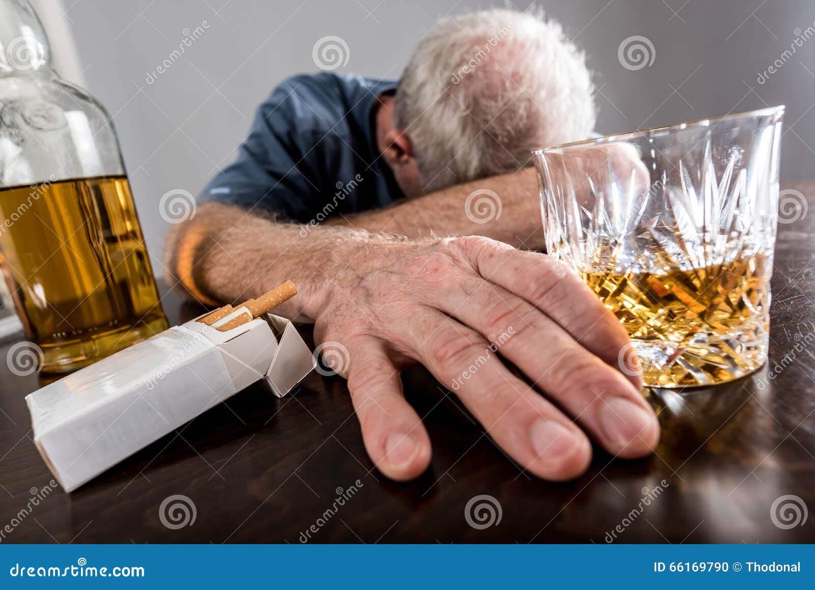 Drunk man slumped on table stock photo. Image of addicted - 66169790