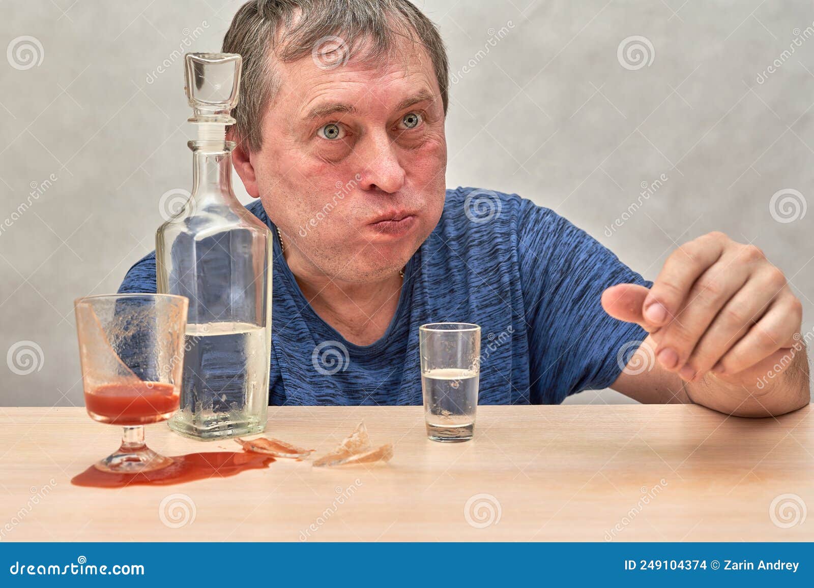 The Drunkard Chews while Eating Alcohol while Sitting at the Table ...