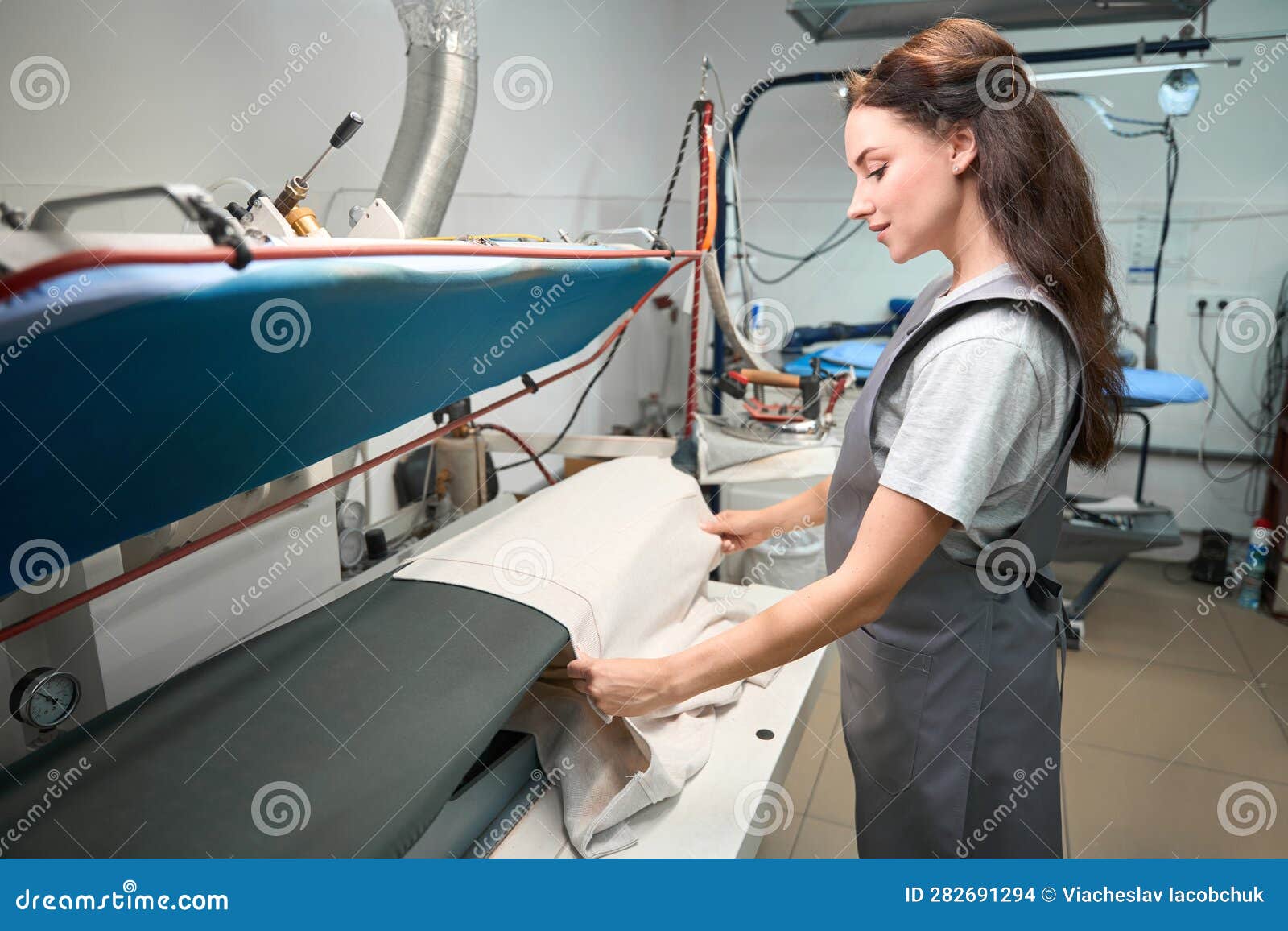 Dry Cleaning Service Operator Putting Coat on Pressing Machine Stock ...