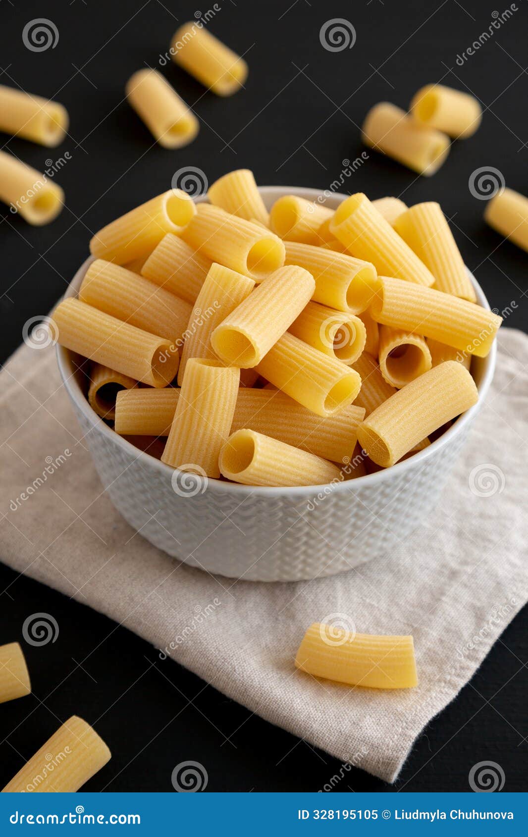 Dry Rigatoni Pasta in a Bowl on a Black Background, Side View Stock ...