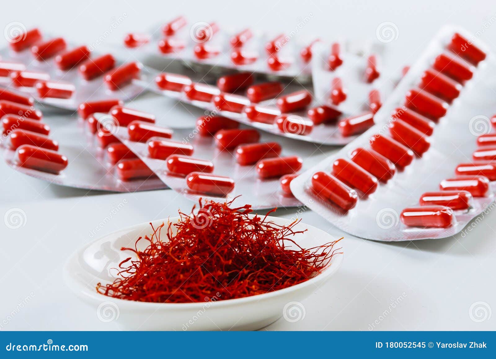 Dry Saffron Threads and Pills in Blister on a White Background Stock ...