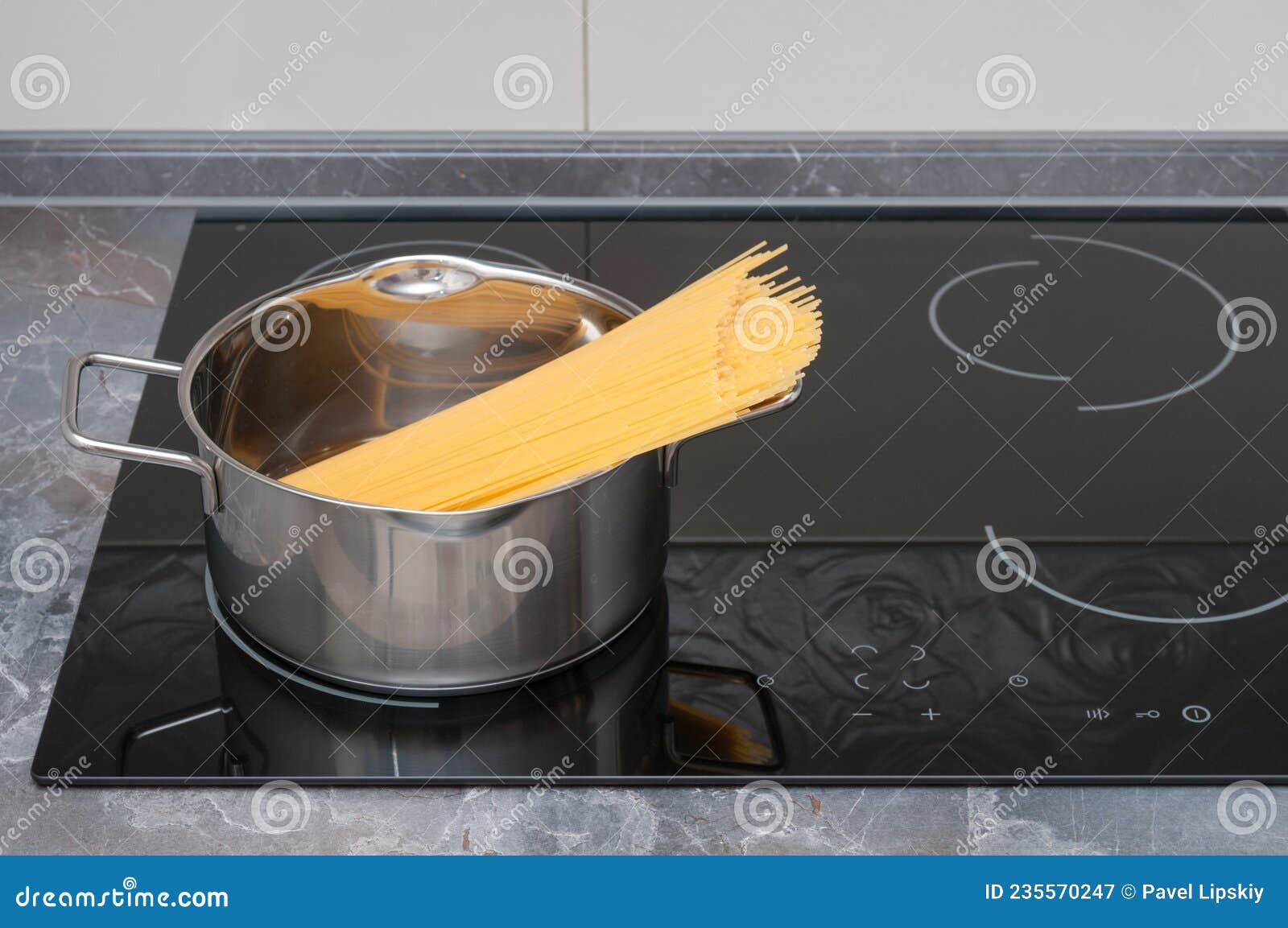 Dry Spaghetti in Stainless Saucepan on Electric Stove in Kitchen Stock ...