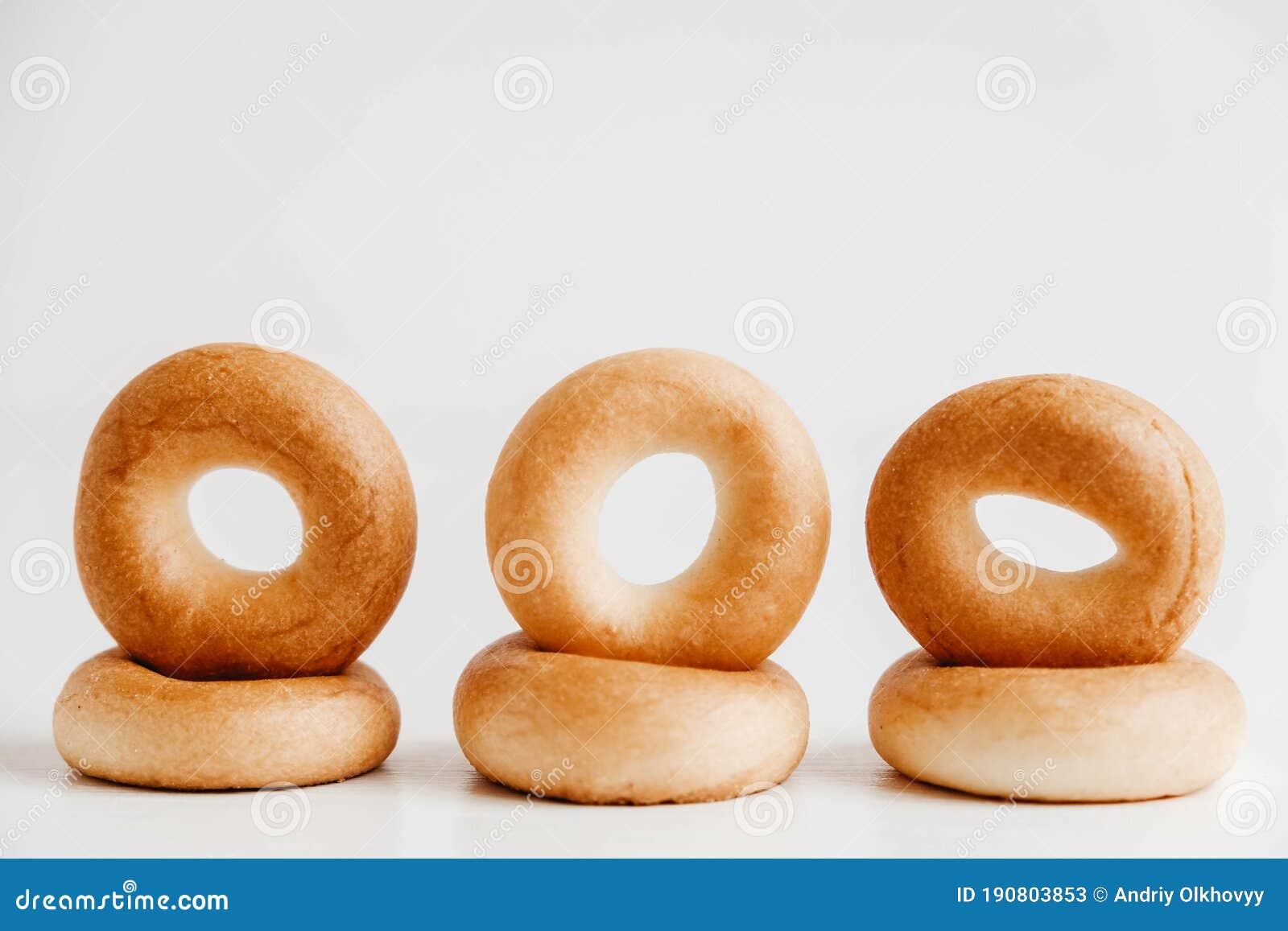 Drying or Mini Round Bagels on a White Wooden Background. Copy, Empty ...