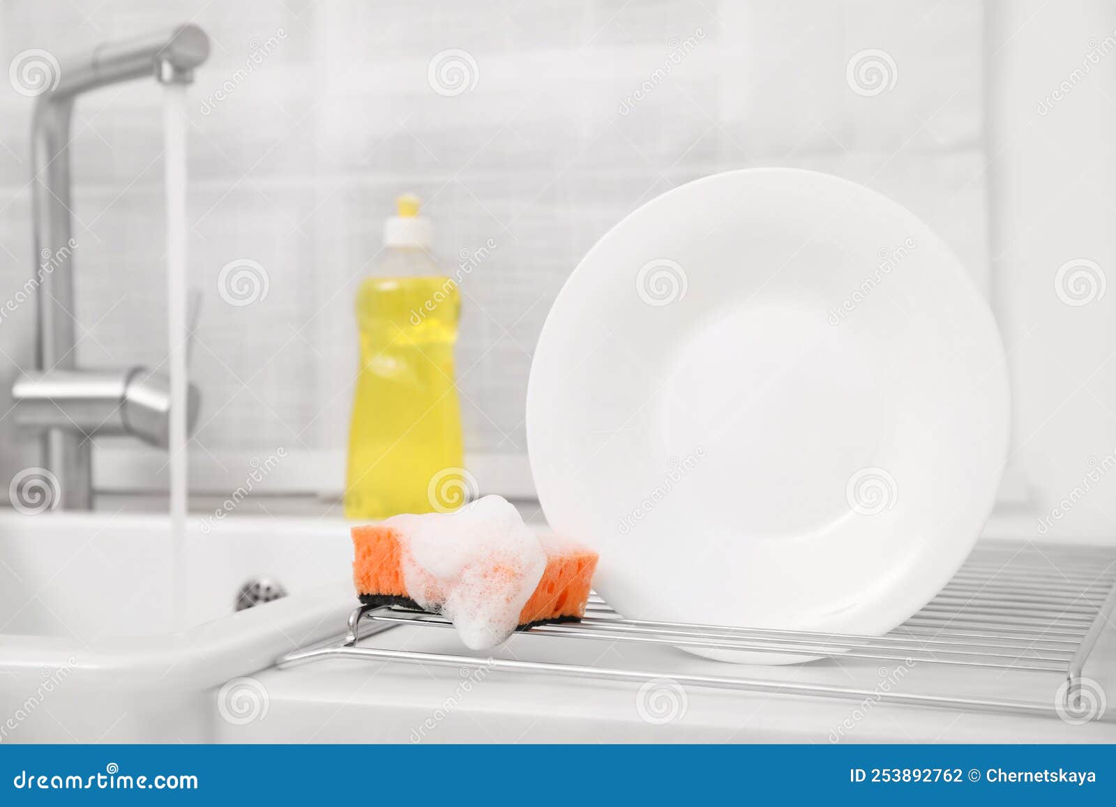 Drying Rack with Clean Plate and Soapy Sponge in Stylish Kitchen Stock ...