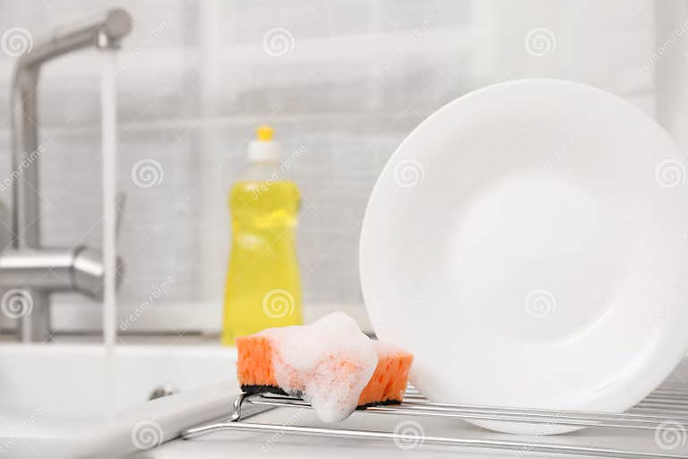 Drying Rack with Clean Plate and Soapy Sponge in Stylish Kitchen Stock ...