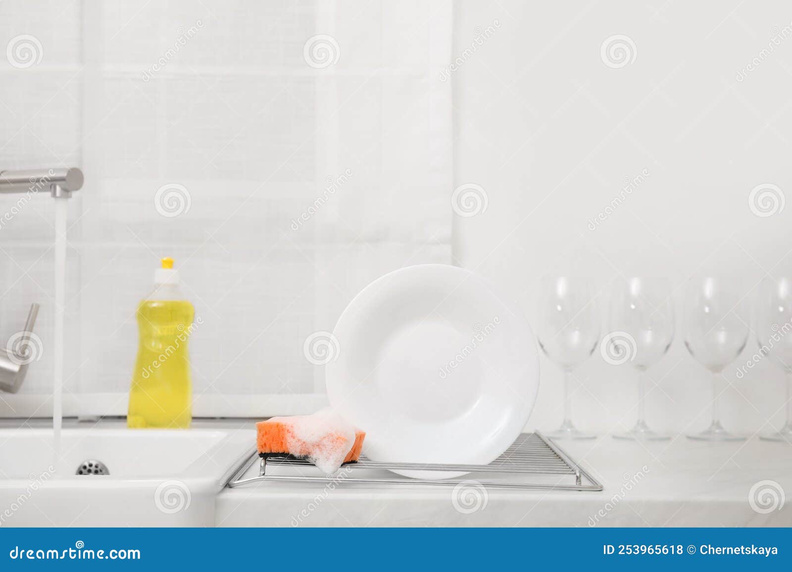 Drying Rack with Clean Plate and Soapy Sponge in Stylish Kitchen Stock ...