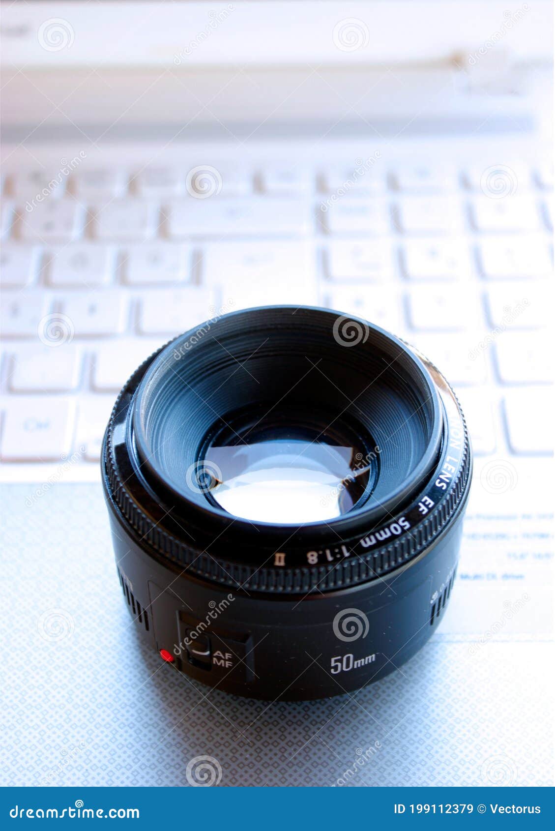 A Professional DSLR Camera Objective is Standing on a White Computer`s ...