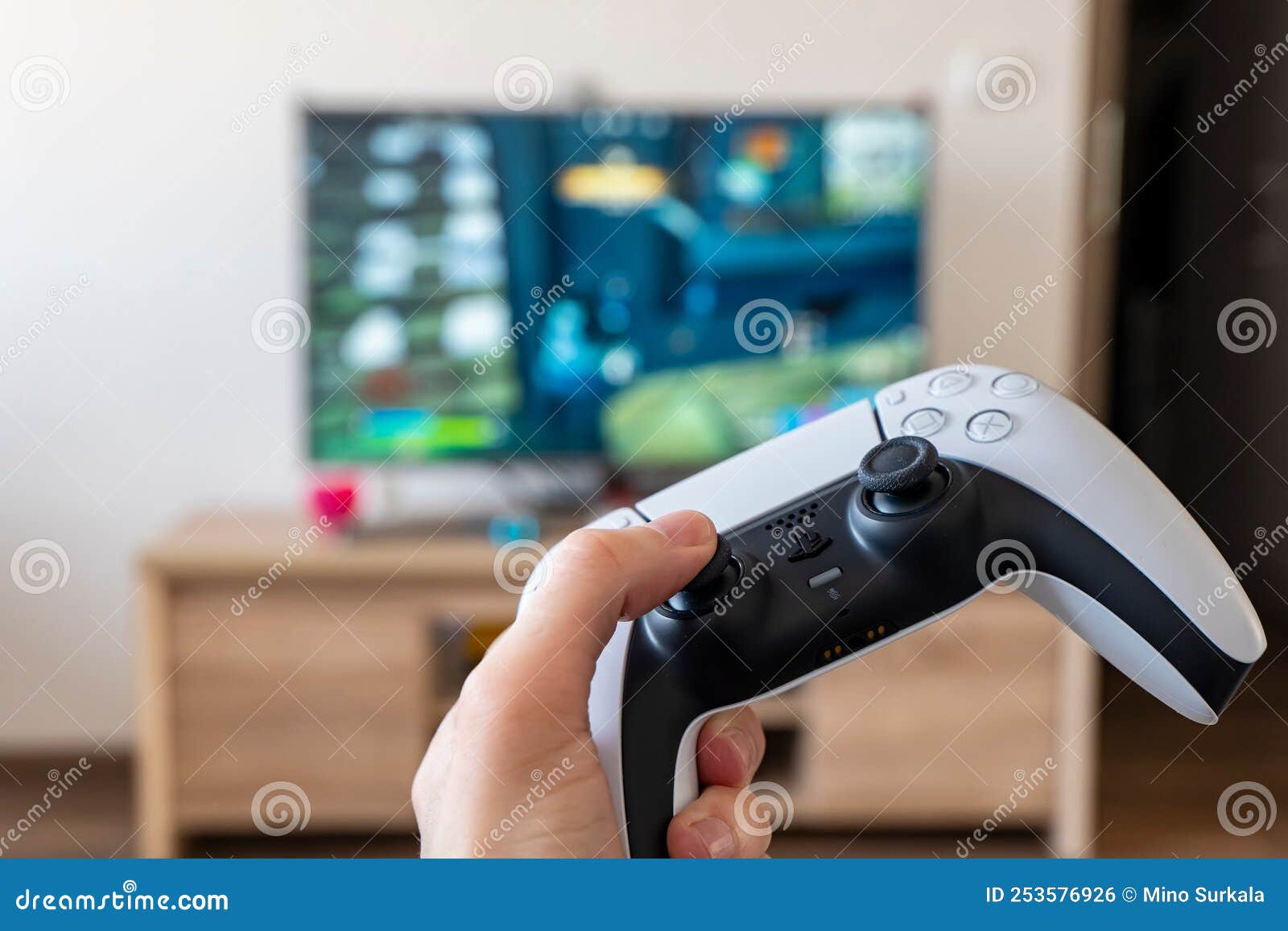 DualSense Controller in a Hand Used for Playing a Computer Game on Sony ...