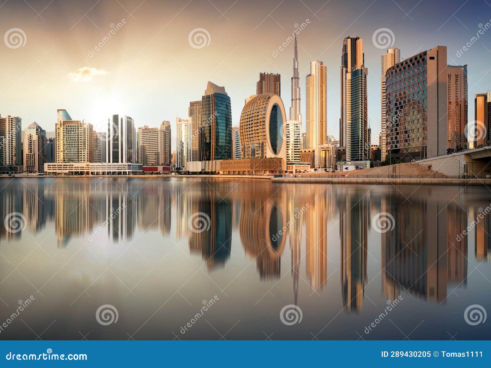 Dubai Skyline with Reflection at Dramatic Sunset with Sun in United ...