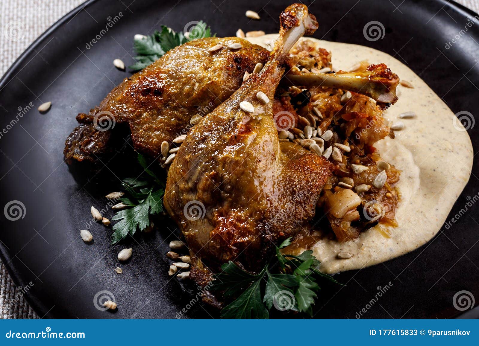Duck Leg with White Sauce on a Dark Plate Stock Image - Image of duck ...