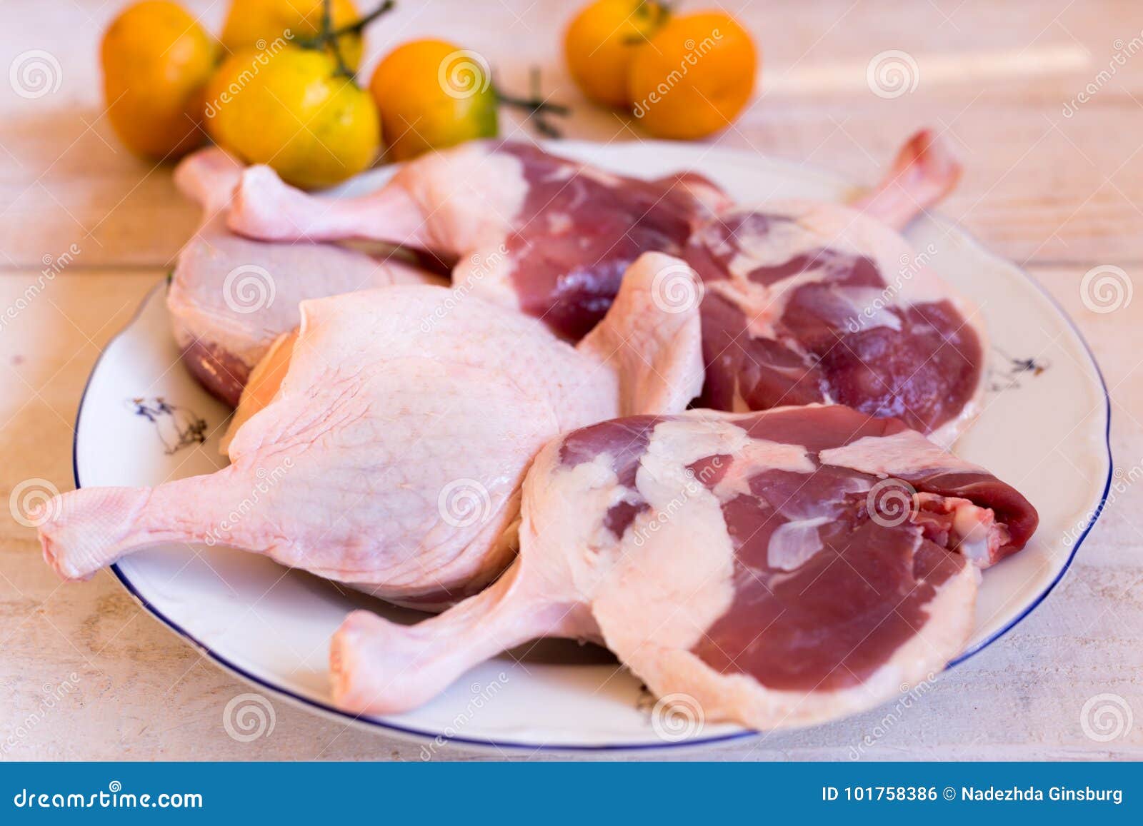Duck Meat Fresh, Raw Duck Legs with Fruit on a Wooden Surface. Stock ...