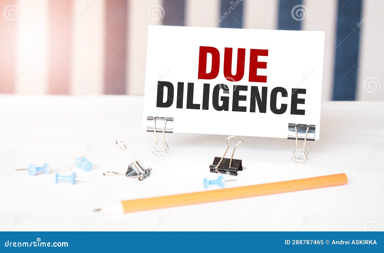 DUE DILIGENCE Sign on Paper on White Desk with Office Tools. Blue and ...
