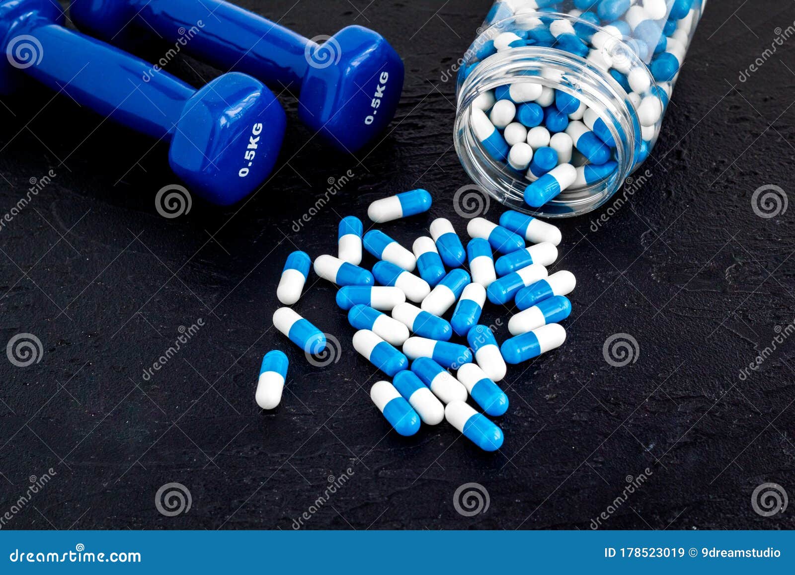Dumbbells and Creatine Capsules - Sport Training Concept - on Black ...