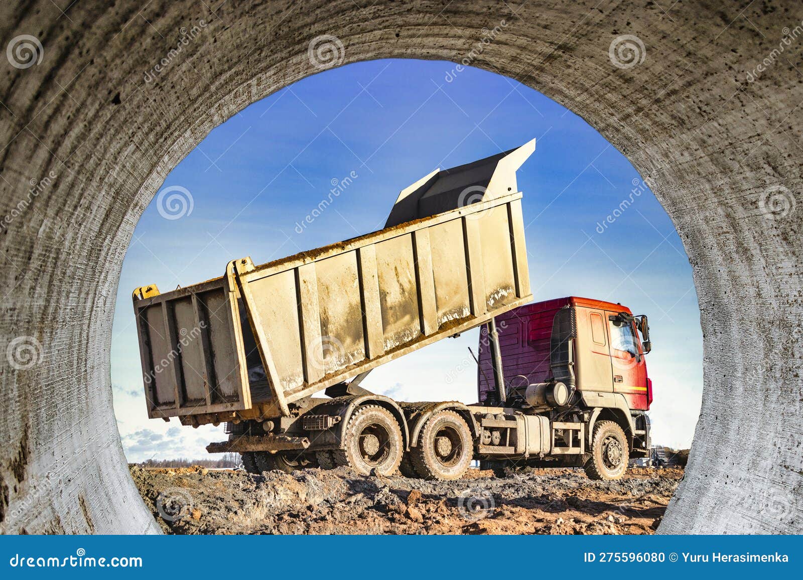 Dump Truck with a Raised Body at a Construction Site. the Process of ...