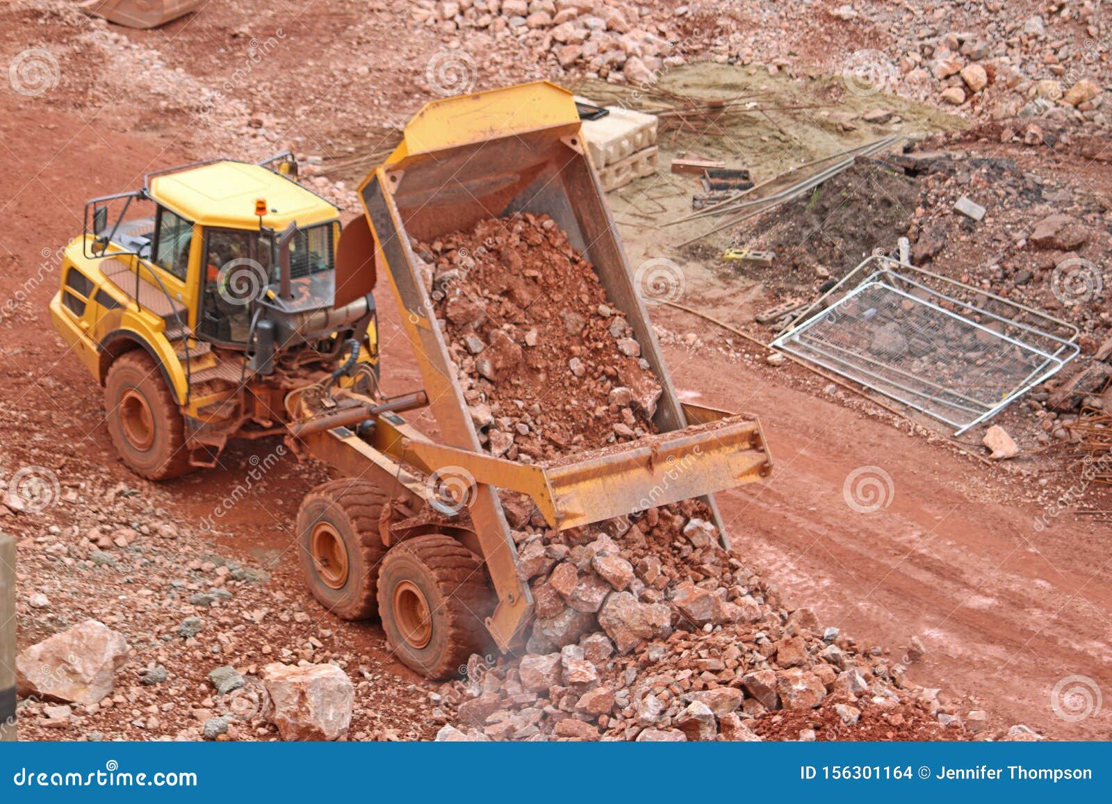 Dump Truck Tipping on a Road Construction Site Stock Photo - Image of ...