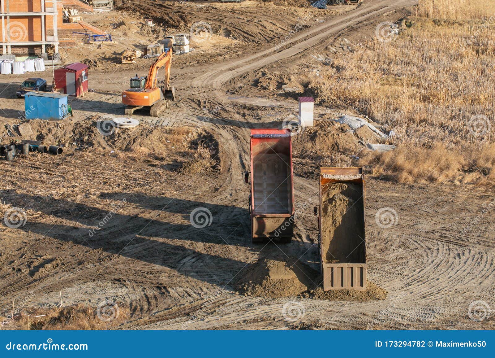 Dump Truck Unloading Process. Dumper Trucks Unloading Earth Material ...