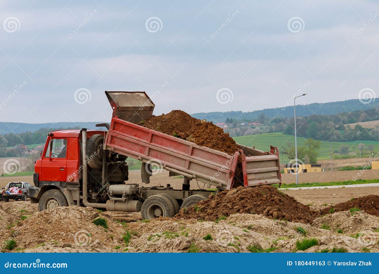 Dump Truck Unloading Soil at Construction Site Stock Image - Image of ...