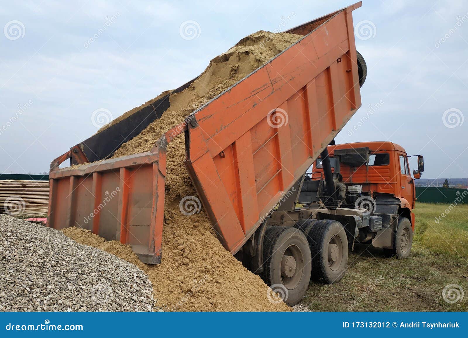 A Dump Truck Unloads Sand at a Construction Site Stock Photo - Image of ...