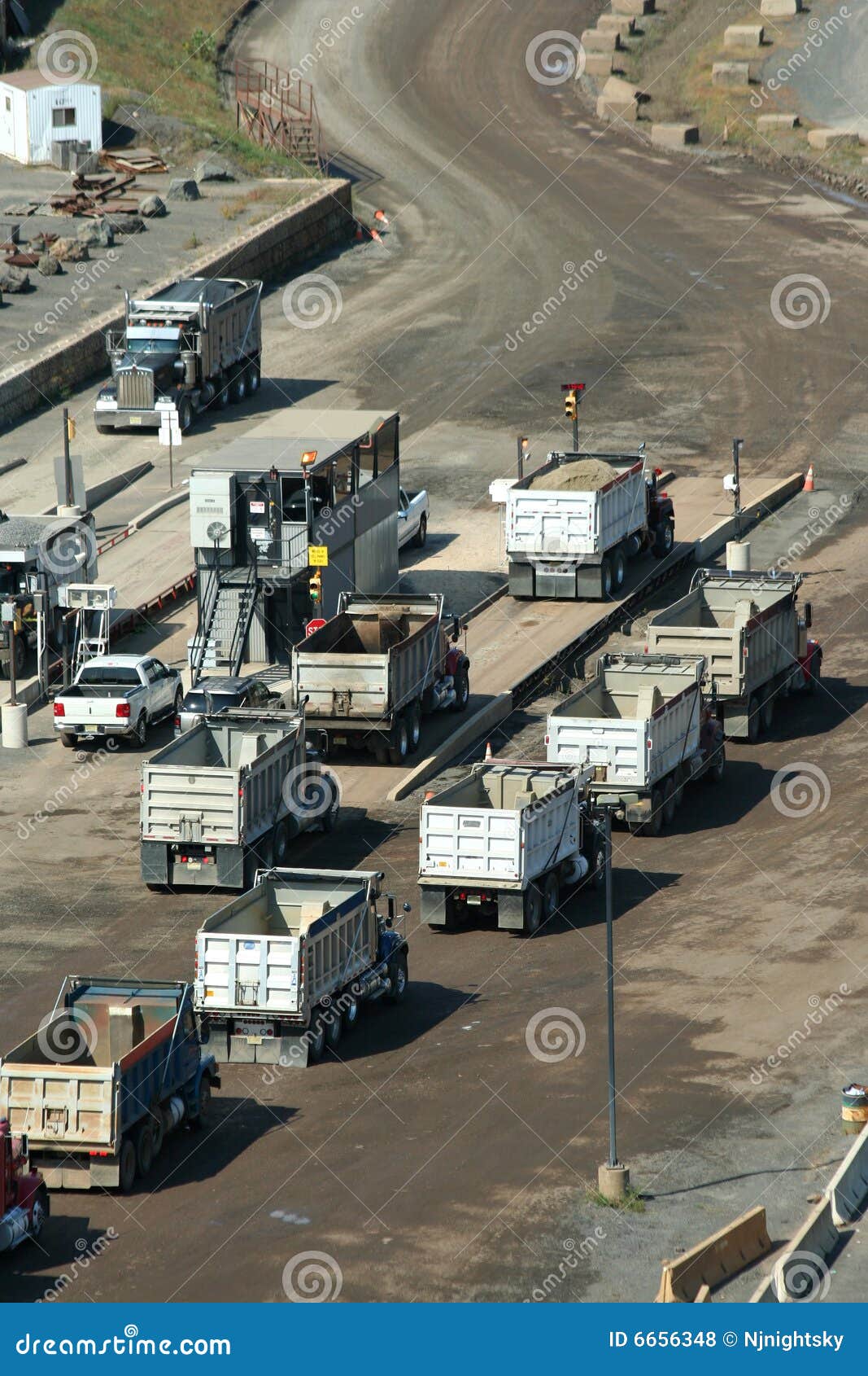 Dump Trucks Lined Up at a Rock Quarry Stock Photo - Image of loader ...