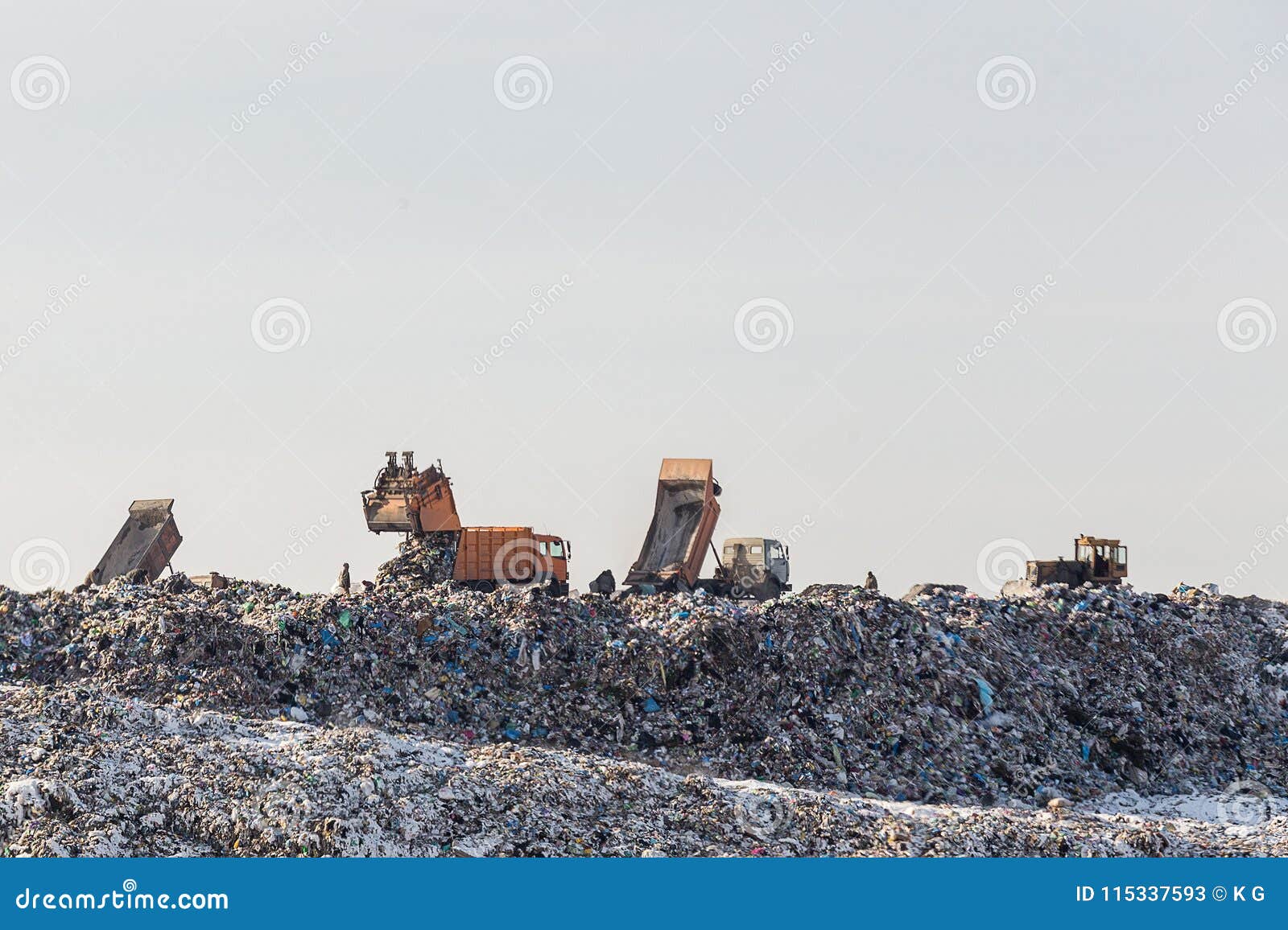 Dump Trucks Unloading Garbage Over Vast Landfill. Environmental ...