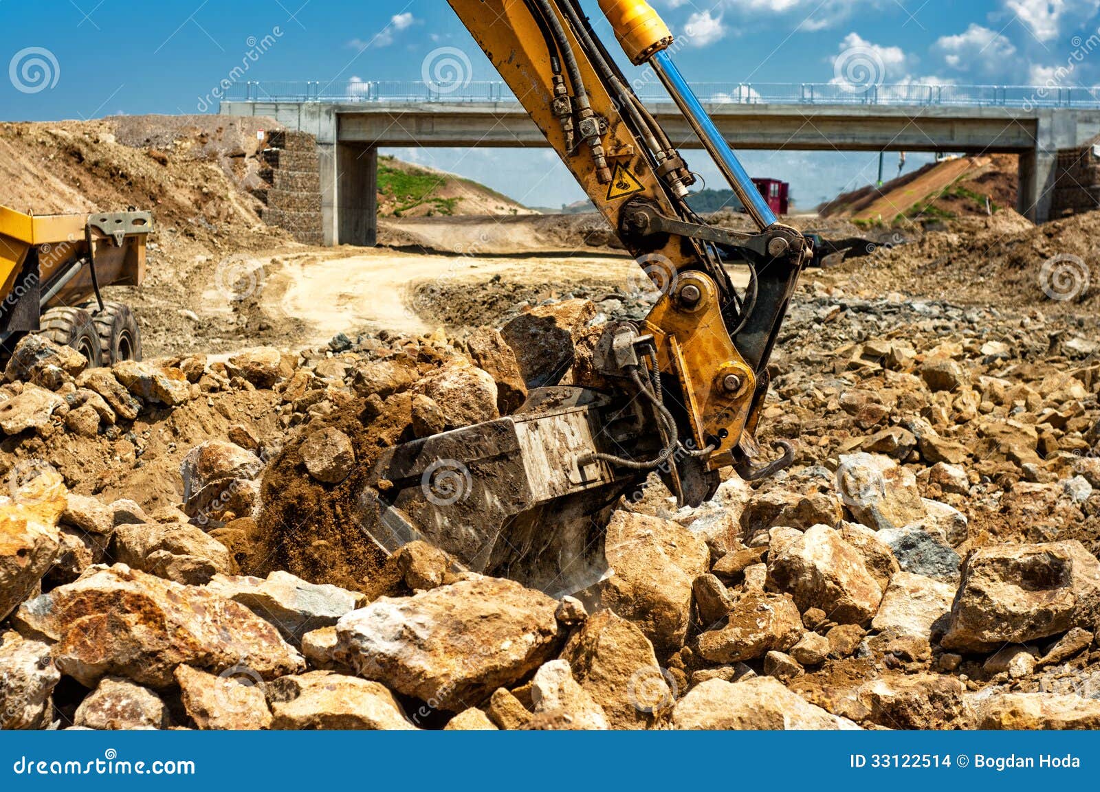 Dumper Truck Loading Rocks and Sand on Construction Site Stock Photo ...