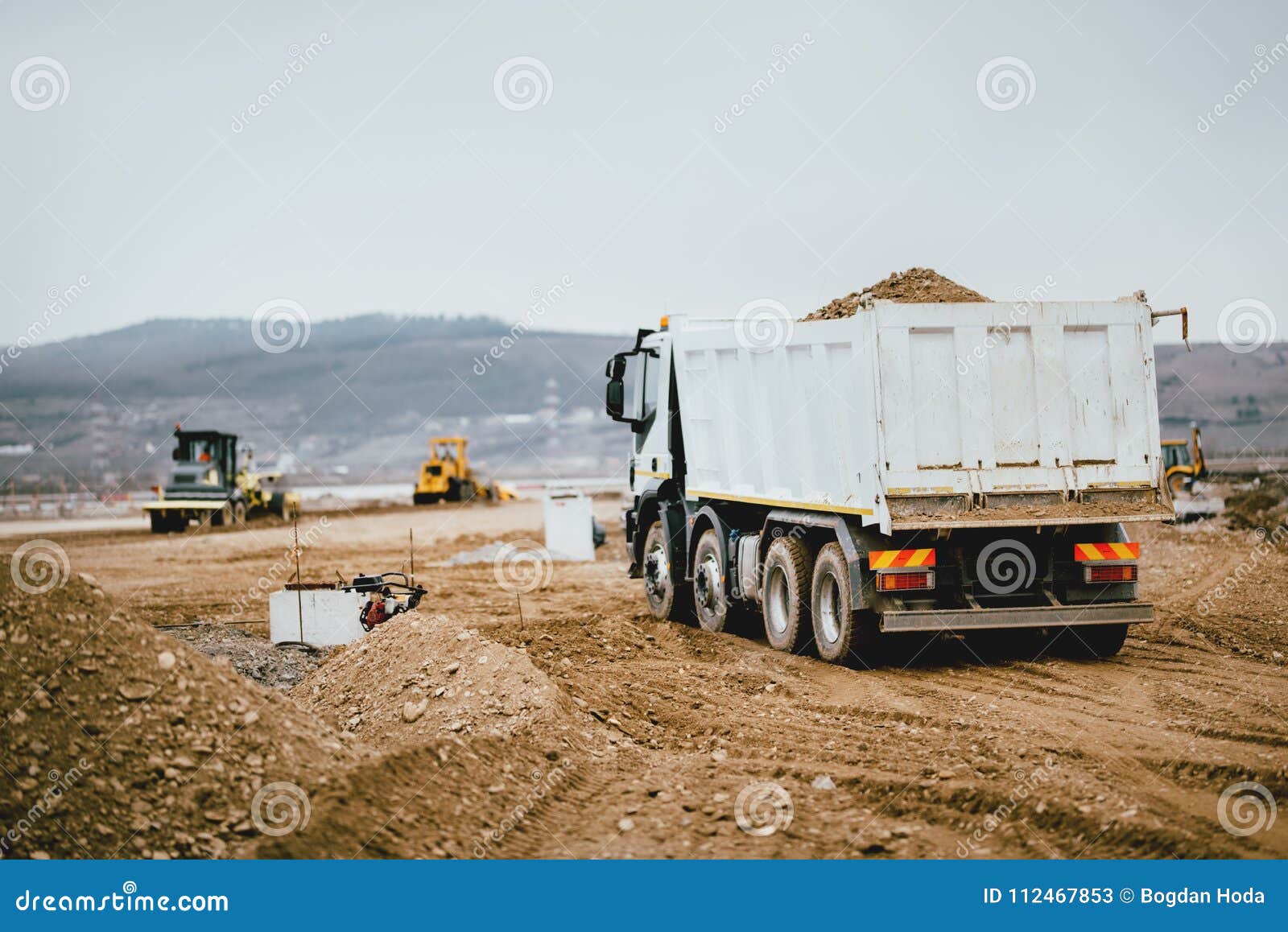 Industrial Dumper Trucks Working On Highway Construction Site, Loading ...