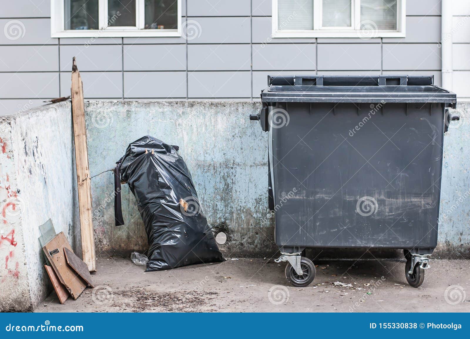 Dumpster on the Grey Wall Background. Garbage Bin Near Housing Stock ...