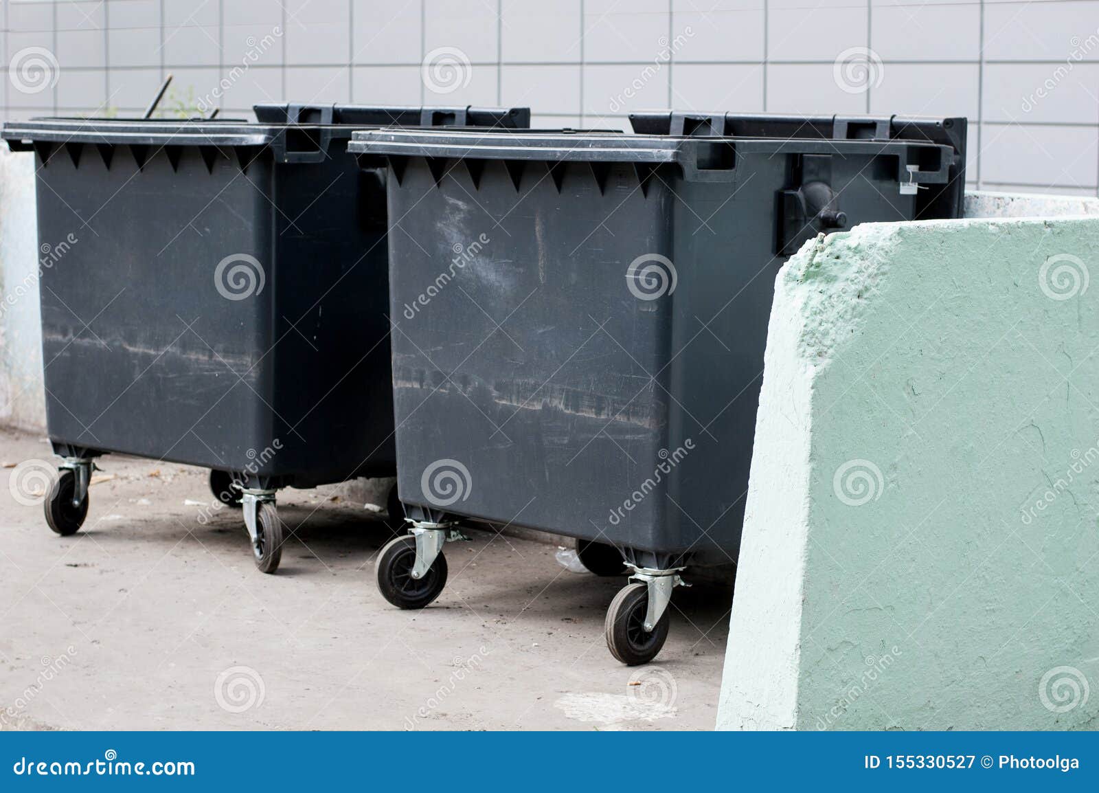 Dumpsters on the Grey Wall Background. Garbage Bins Near Housing Stock ...
