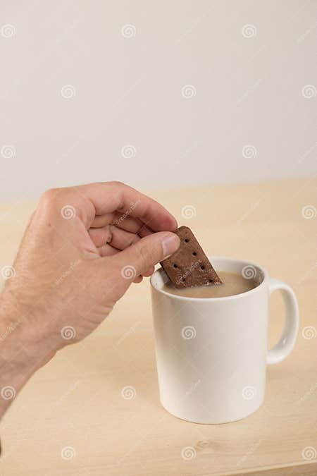 Dunking biscuit in tea stock image. Image of afternoon - 61810907