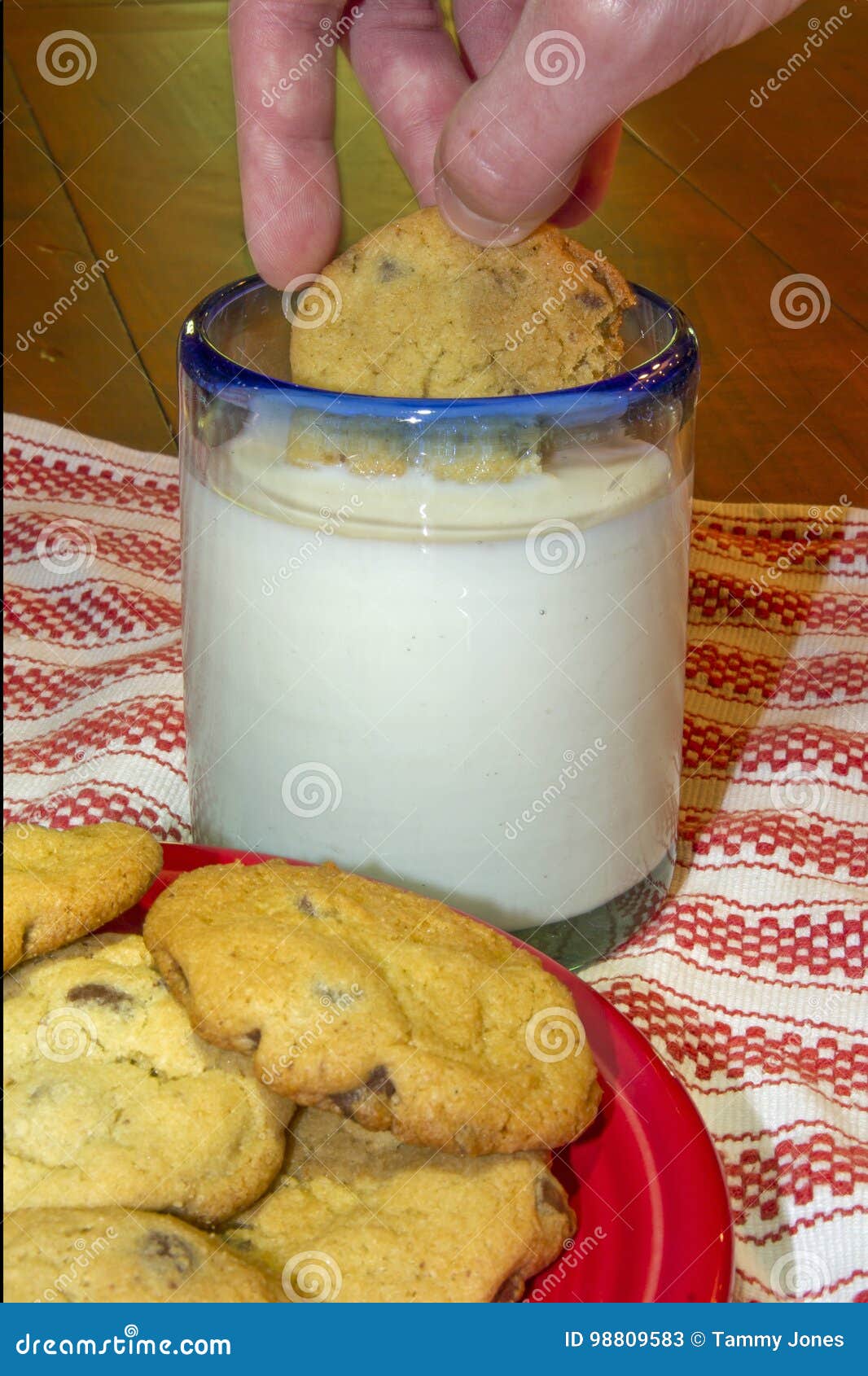 Dunking cookie in milk stock image. Image of confectionary - 98809583