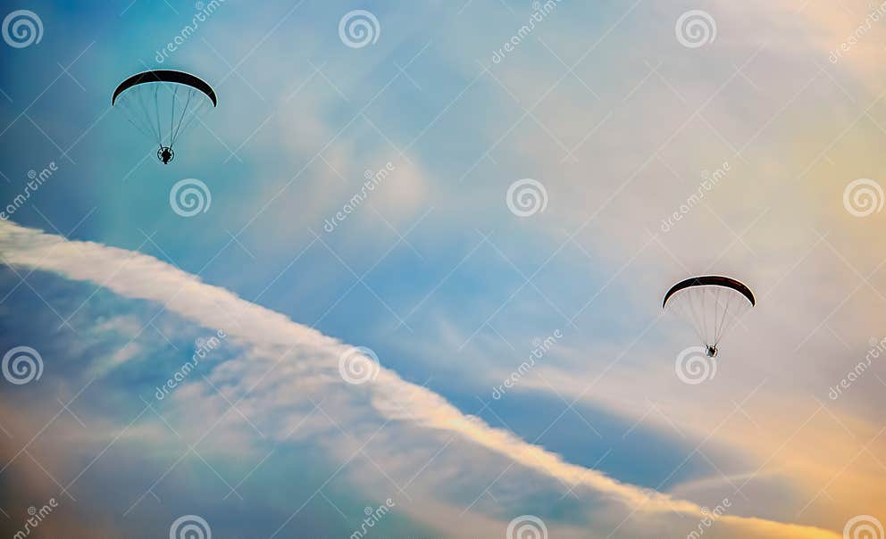 Duo of Paragliders Flying into the Sunset Stock Photo - Image of ...