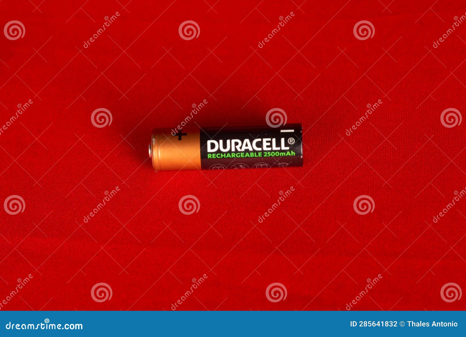 A Duracell Brand Rechargeable Battery Isolated on a Red Background ...