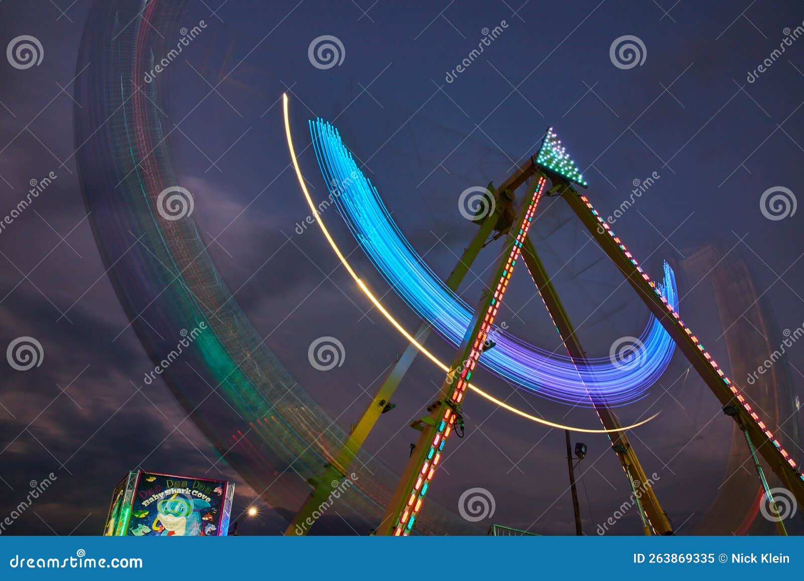 Dusk Carnival Ride Swinging with Blurred Lights at County Fair Stock ...