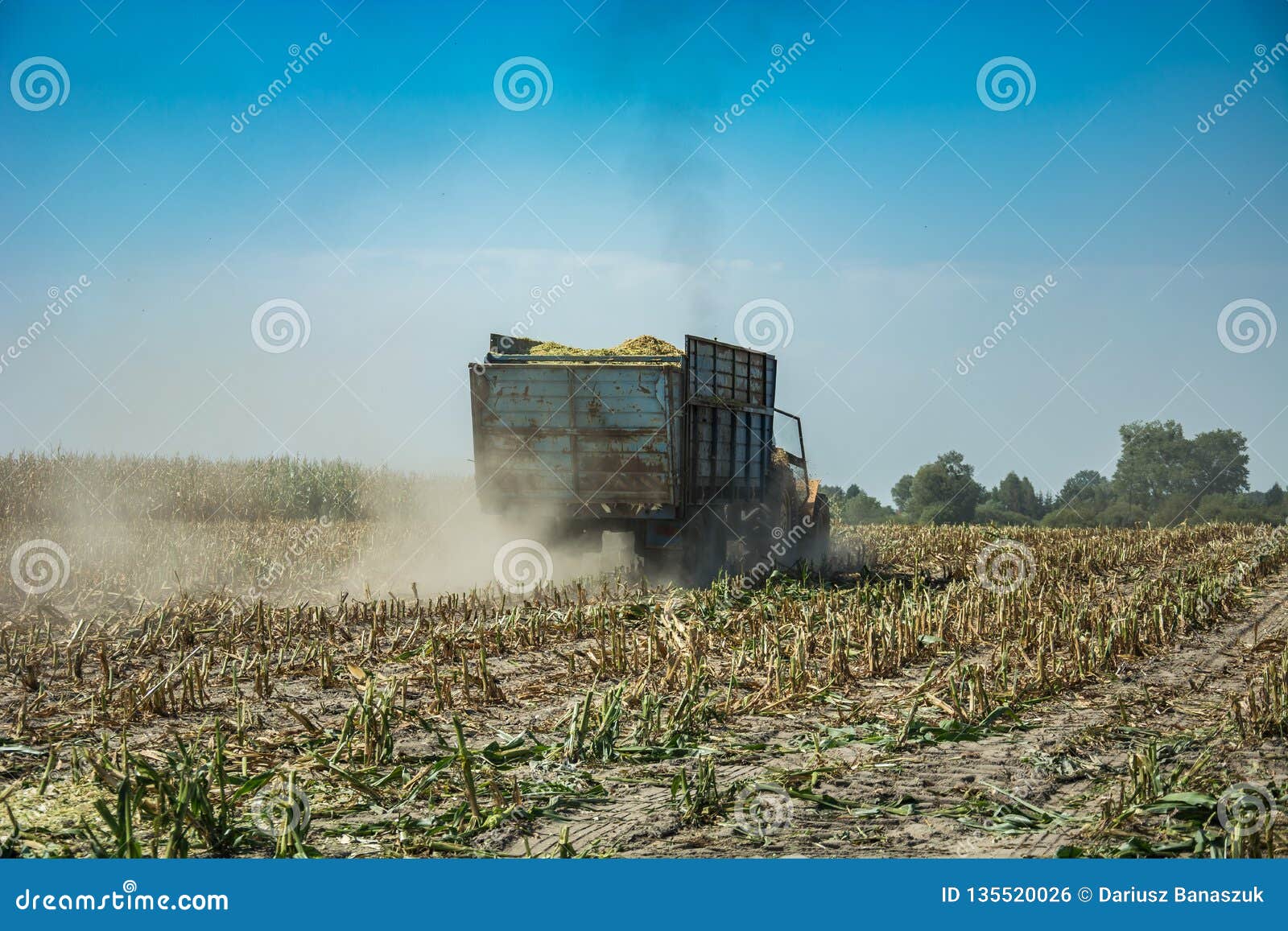 Dust Behind a Tractor with a Trailer in the Field Stock Photo - Image ...