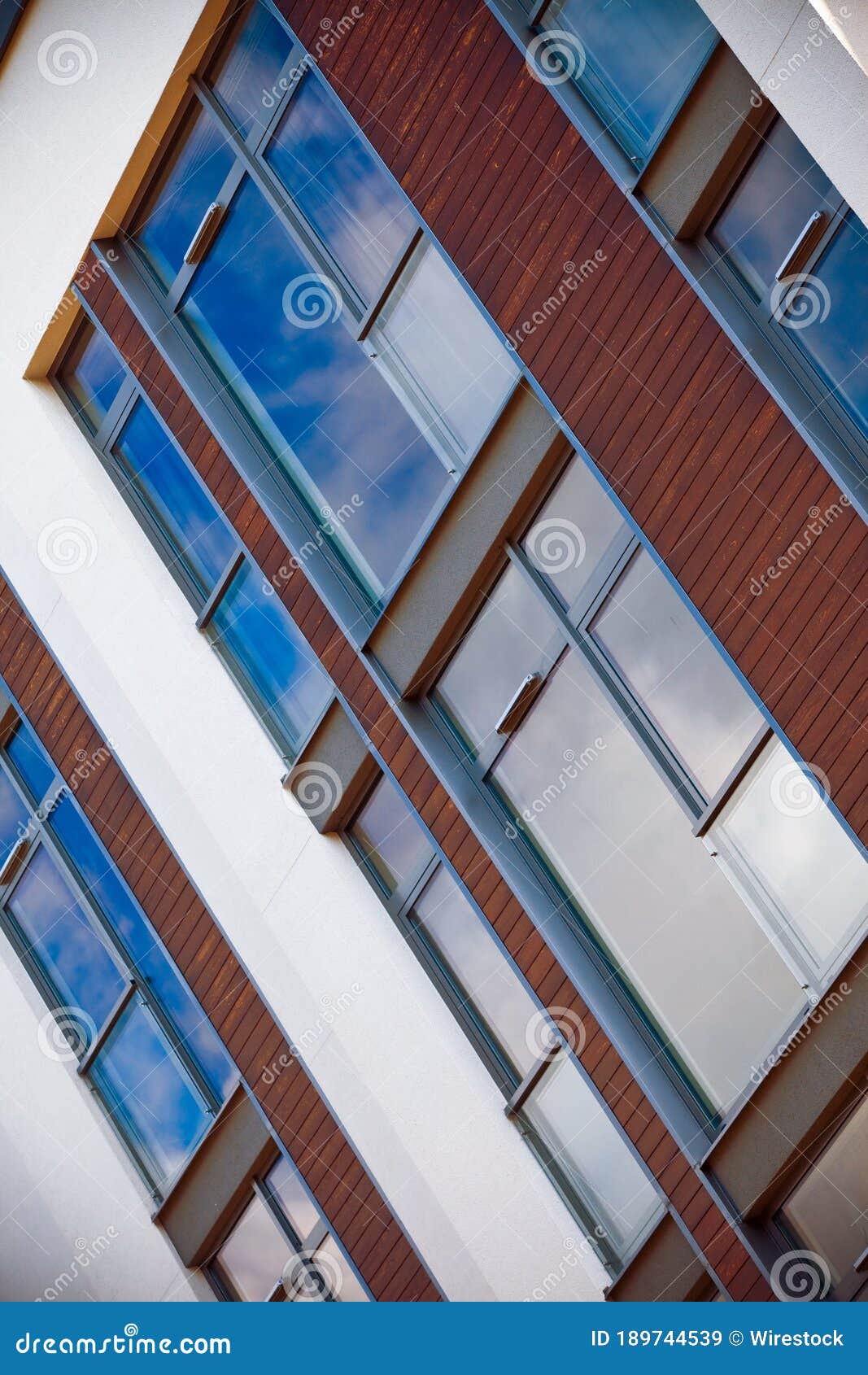 Dutch Angle Shot of the Clouds in the Sky Reflected on the Windows of a ...