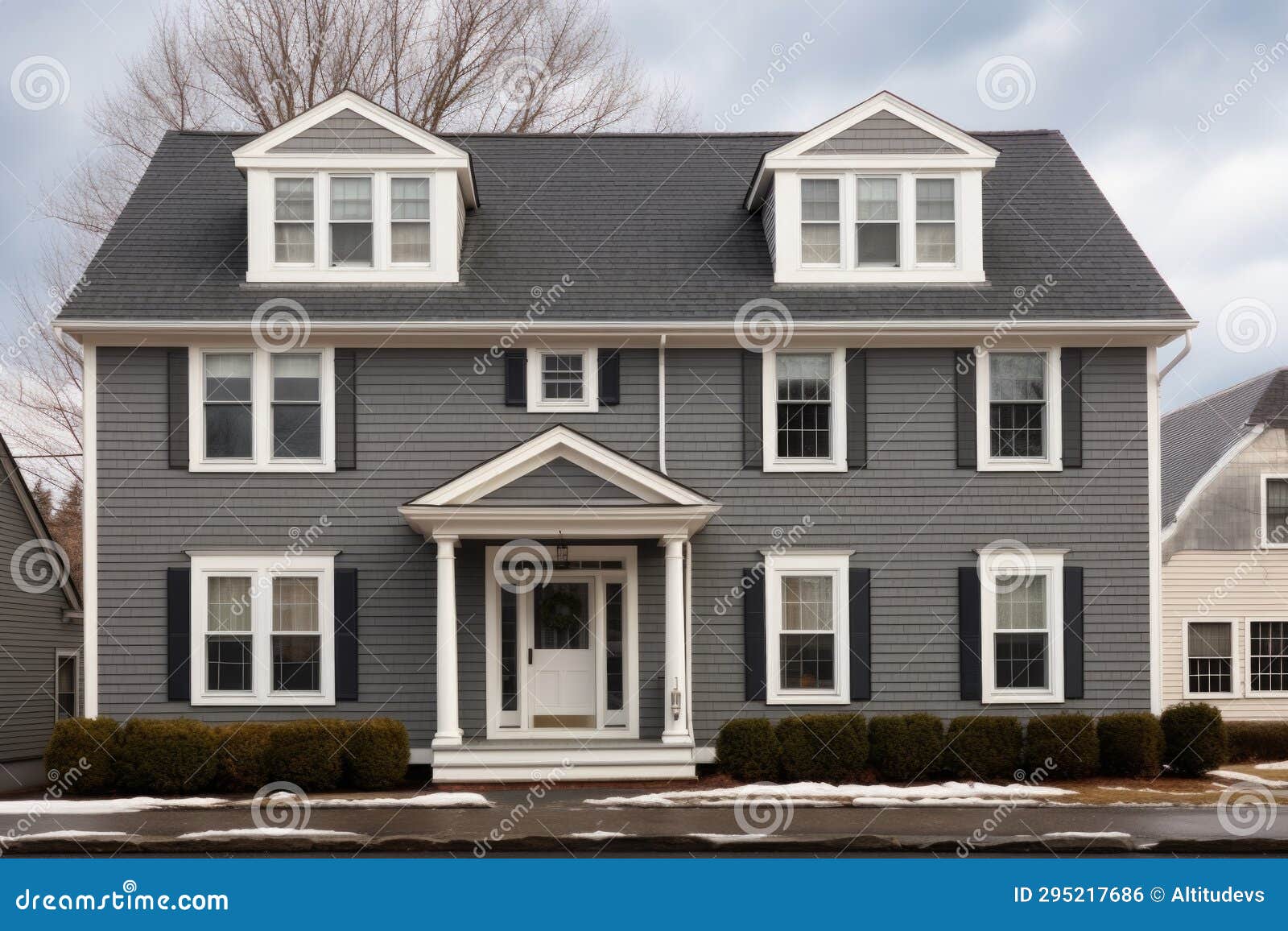Dutch Colonial Facade with Enhanced Dormer Windows Under Gray Sky Stock ...