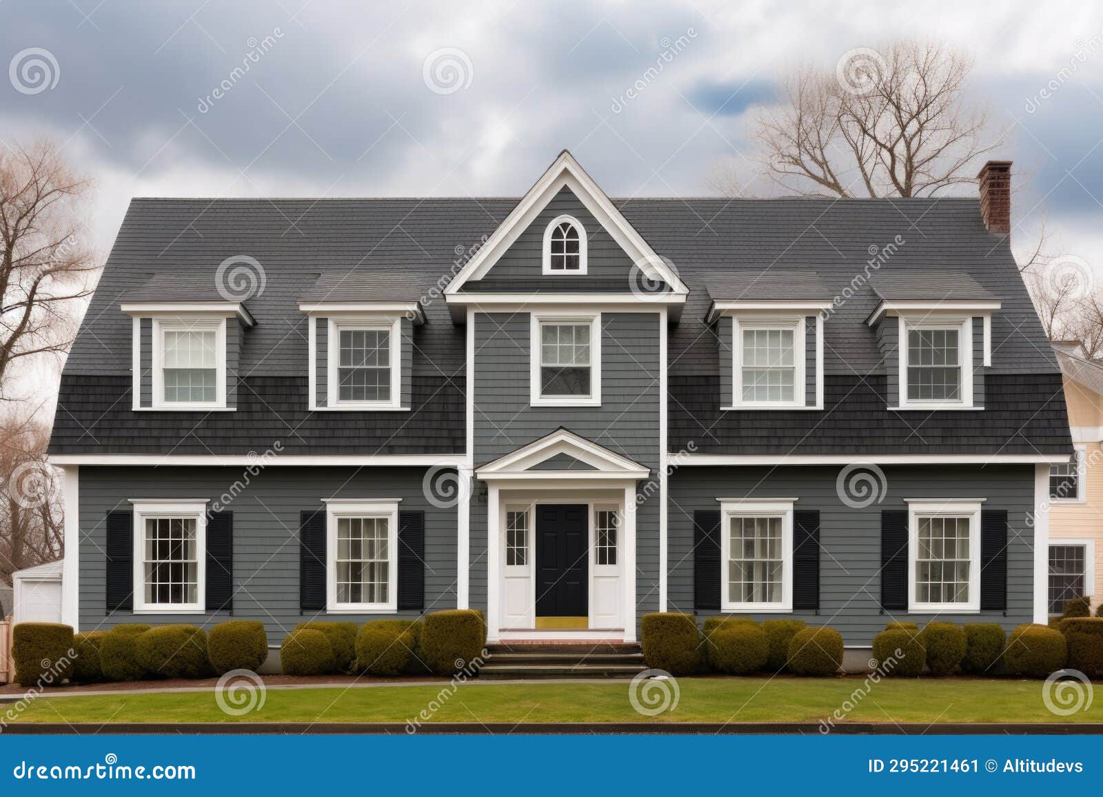 Dutch Colonial Facade with Enhanced Dormer Windows Under Gray Sky Stock ...