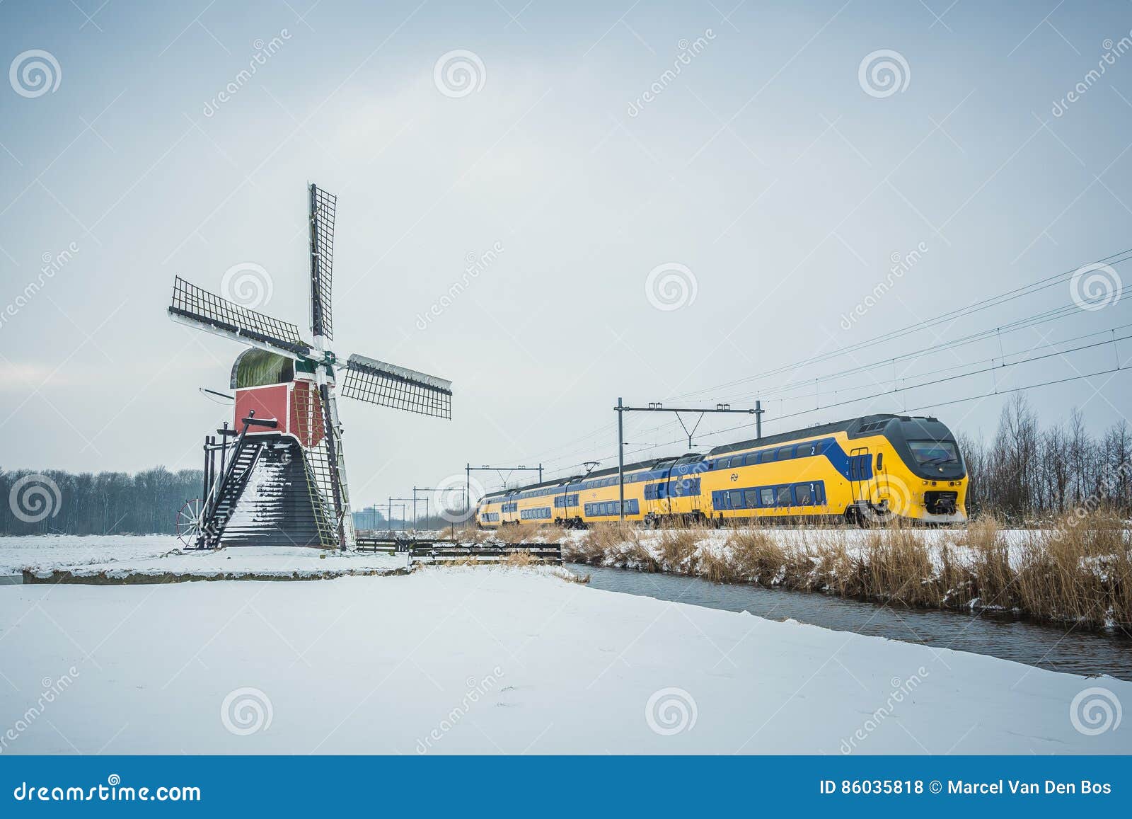 Dutch Train and Windmill in Winter Landscape Editorial Stock Photo ...