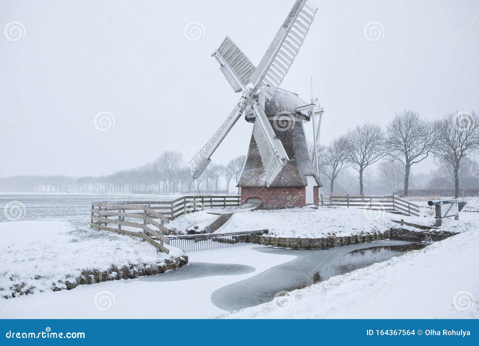 Dutch windmill in snow stock photo. Image of architecture - 164367564