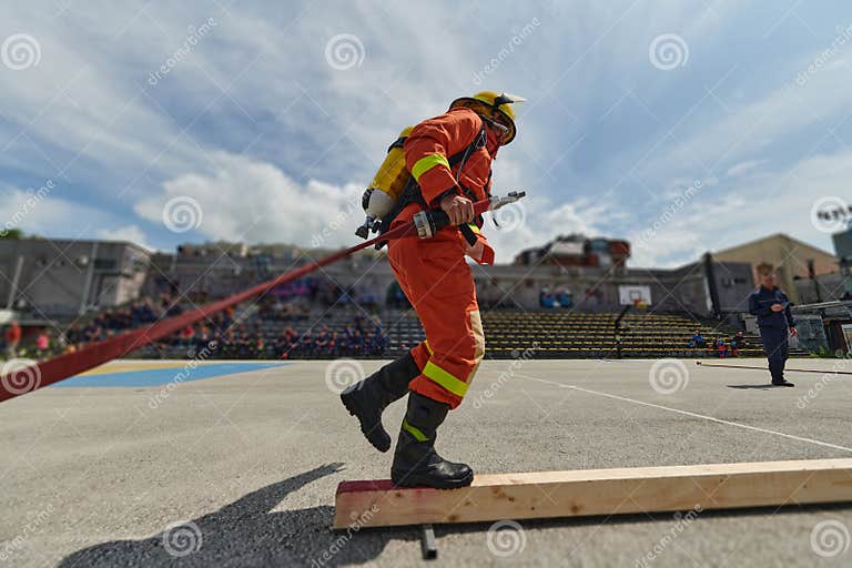 In a Dynamic Display of Synchronized Teamwork, Firefighters Hustle To ... In a Dynamic Display of Synchronized Teamwork, Firefighters Hustle To ...