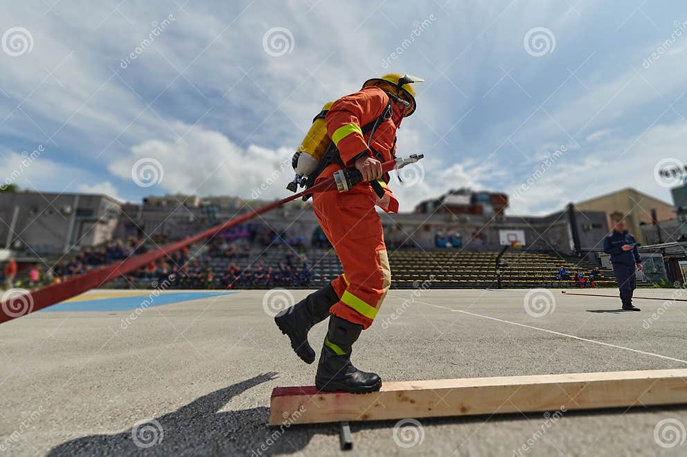 In a Dynamic Display of Synchronized Teamwork, Firefighters Hustle To ...