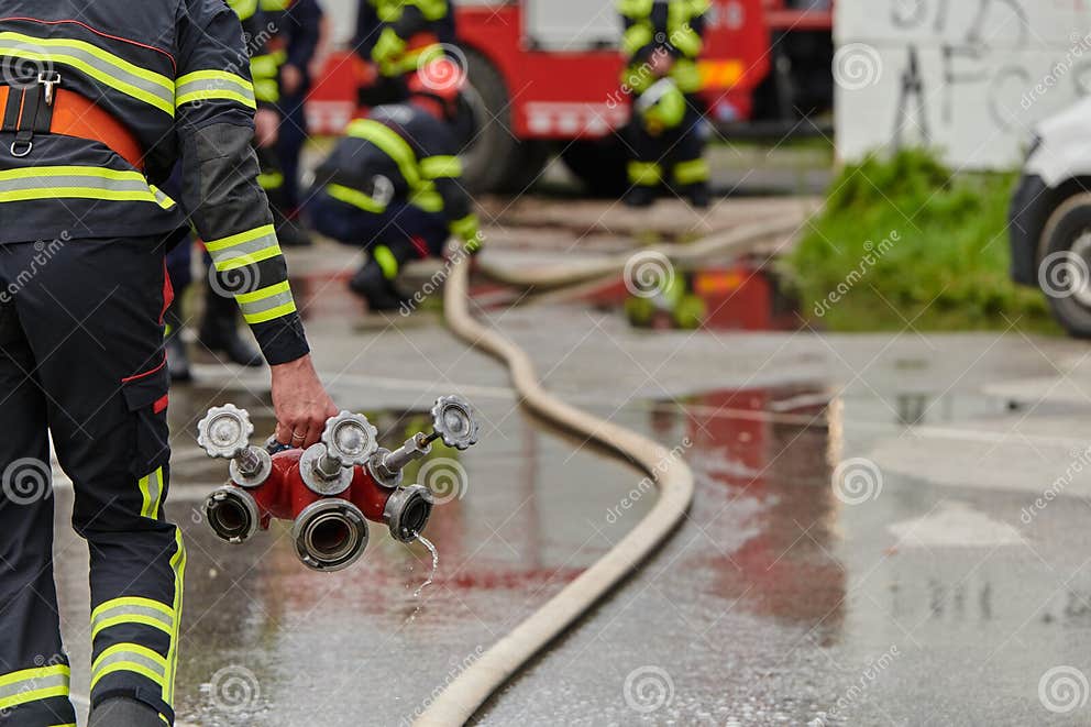 In a Dynamic Display of Synchronized Teamwork, Firefighters Hustle To ...