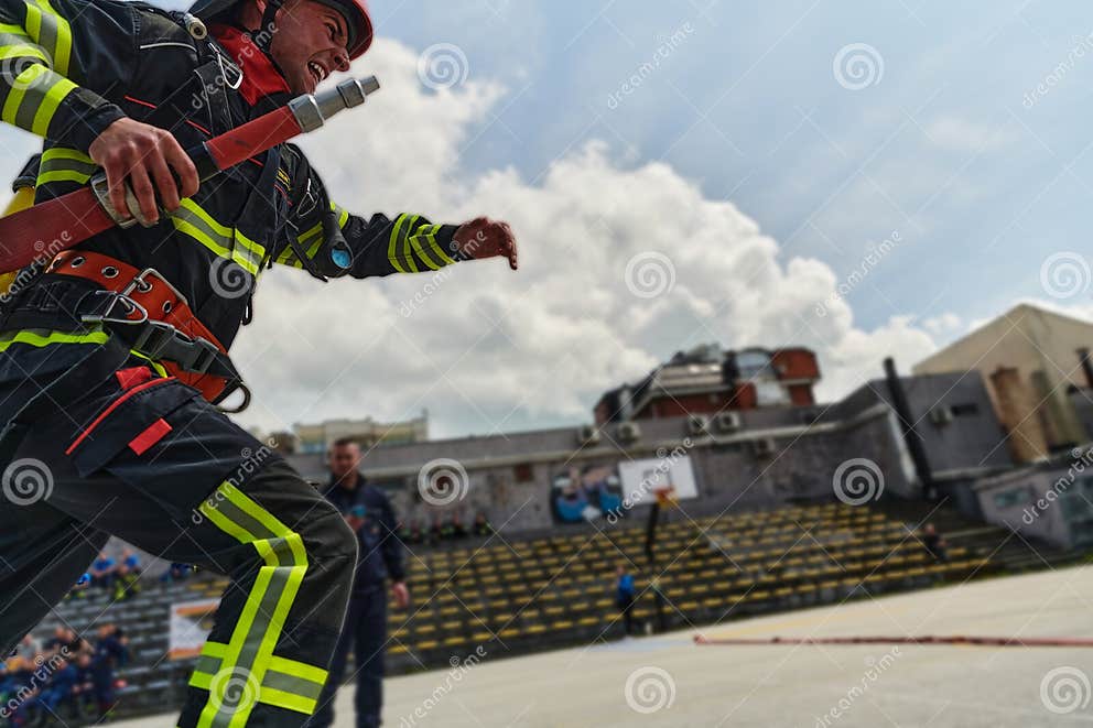 In a Dynamic Display of Synchronized Teamwork, Firefighters Hustle To ...