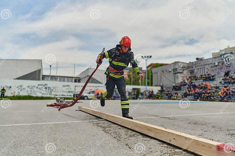 In a Dynamic Display of Synchronized Teamwork, Firefighters Hustle To ...