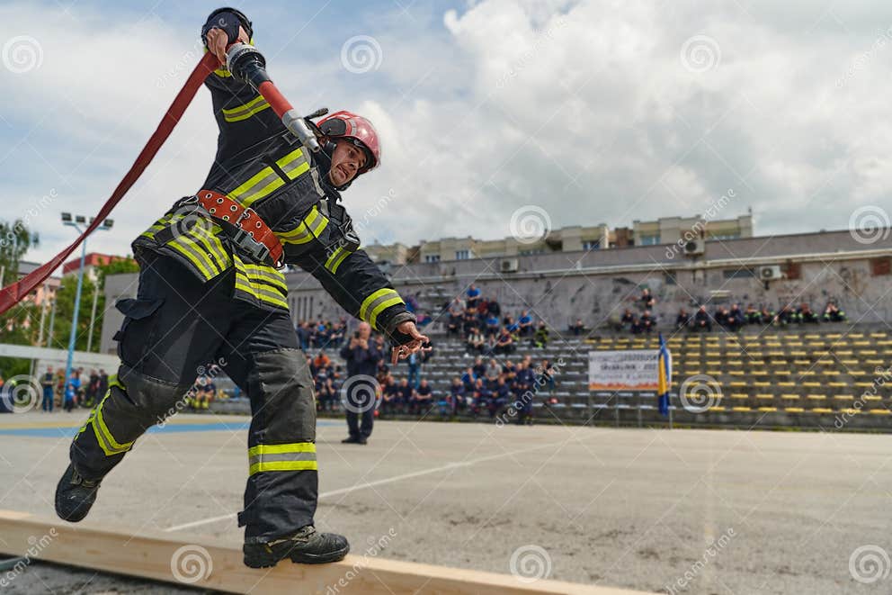In a Dynamic Display of Synchronized Teamwork, Firefighters Hustle To ...
