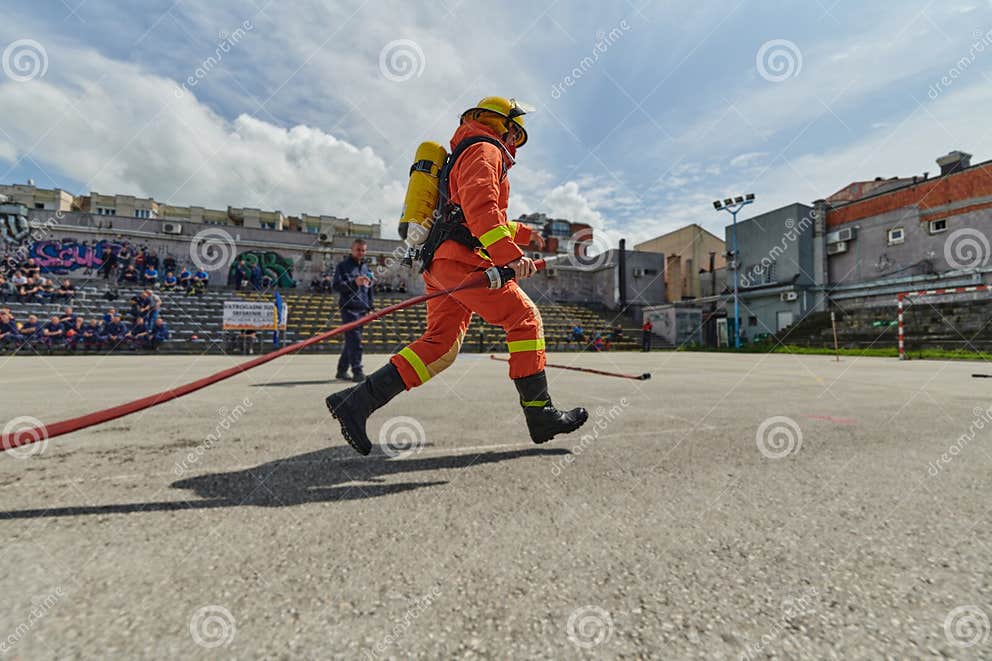 In a Dynamic Display of Synchronized Teamwork, Firefighters Hustle To ...