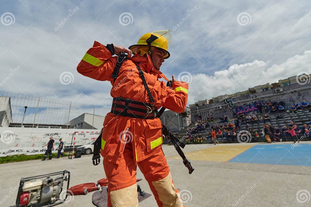 In a Dynamic Display of Synchronized Teamwork, Firefighters Hustle To ...